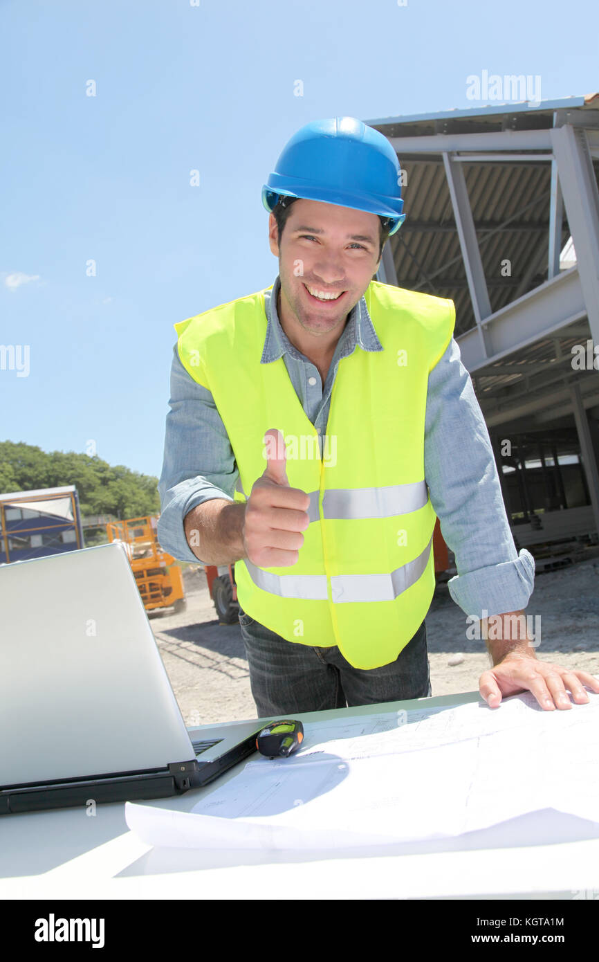 Happy worker on construction site Stock Photo - Alamy