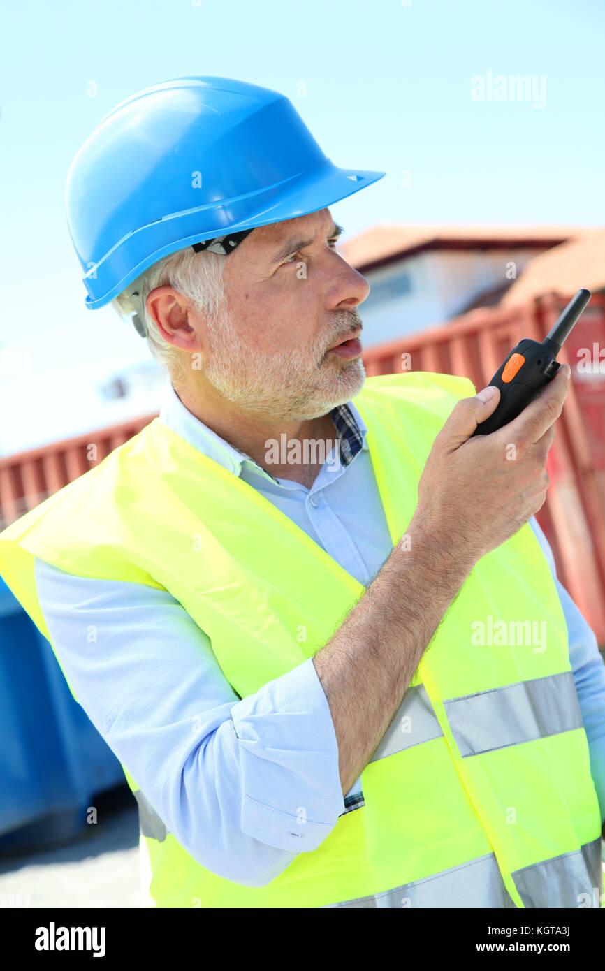 Site manager using walkie-talkie Stock Photo - Alamy