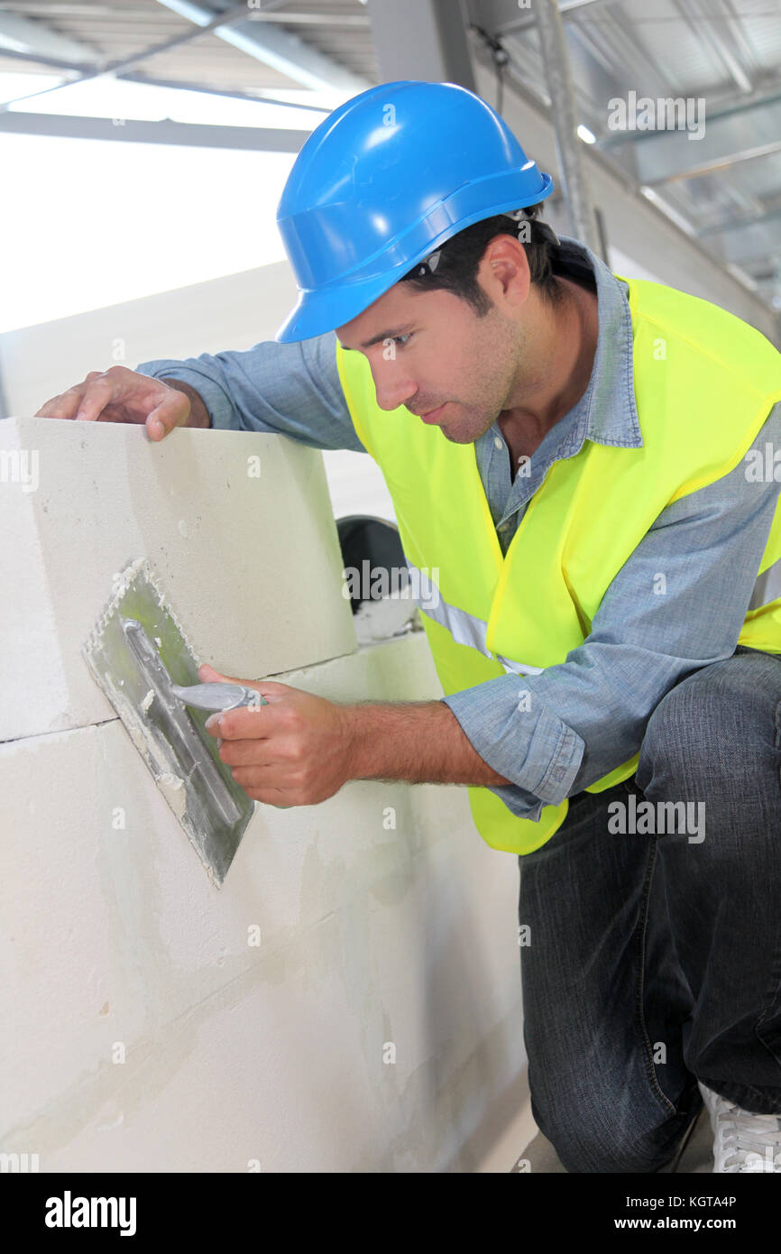 Bricklayer at work on construction site Stock Photo - Alamy