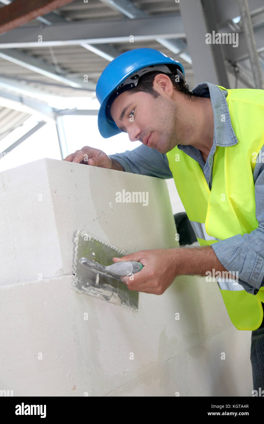 Bricklayer at work on construction site Stock Photo - Alamy