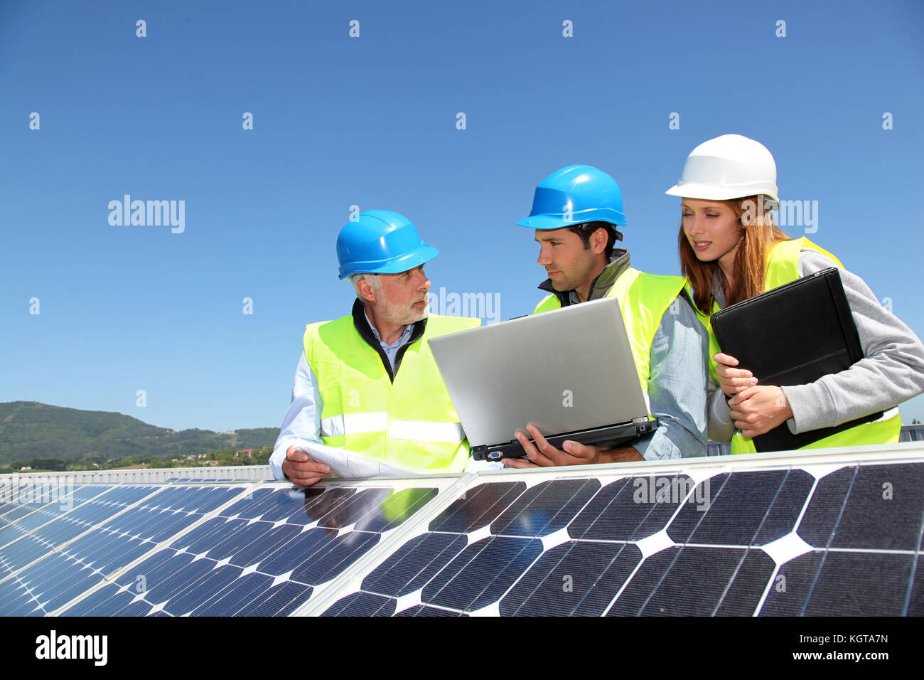Group of engineers meeting on building roof Stock Photo - Alamy