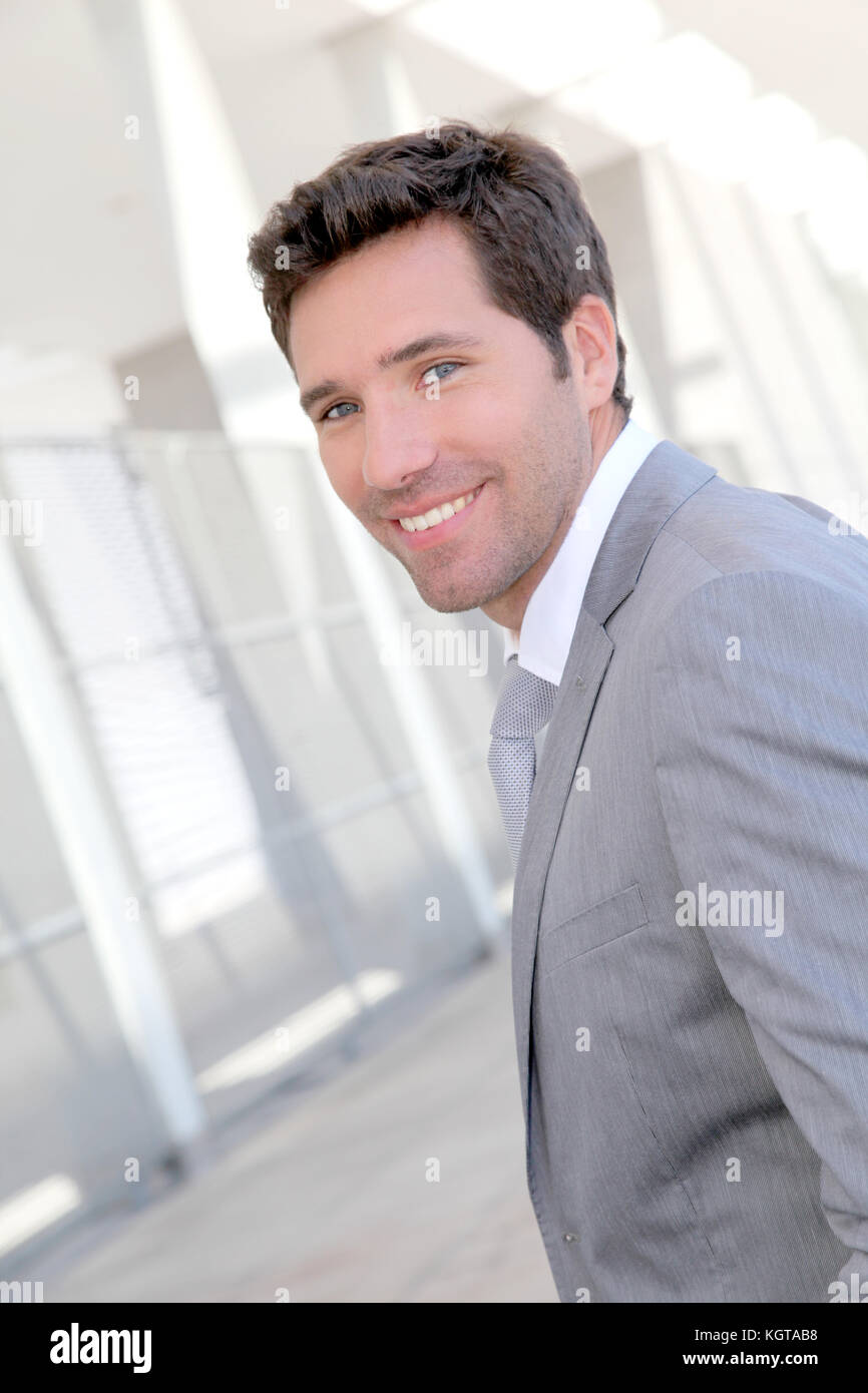 Handsome businessman standing in front of building Stock Photo - Alamy