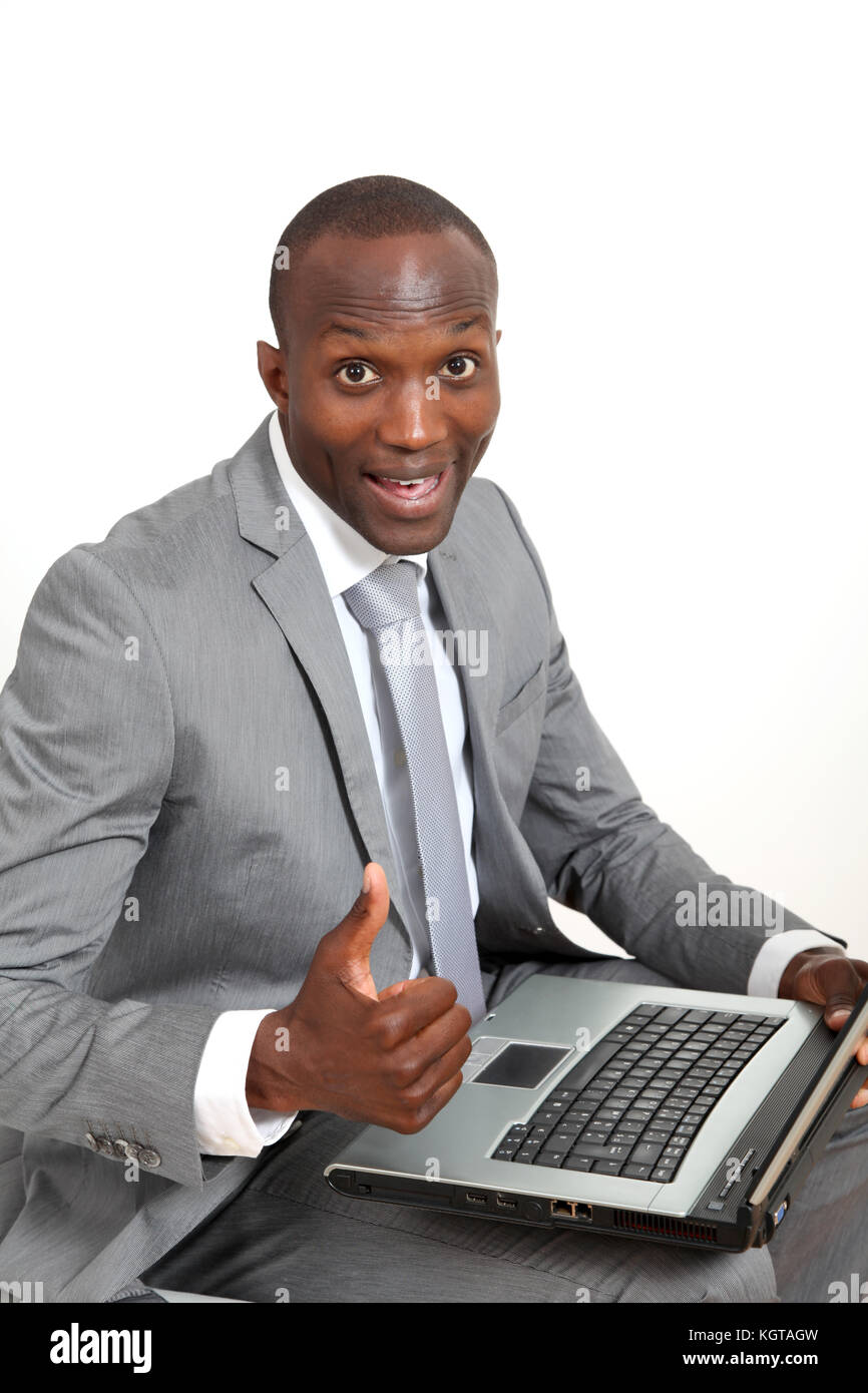Businessman working on laptop in waiting room Stock Photo - Alamy