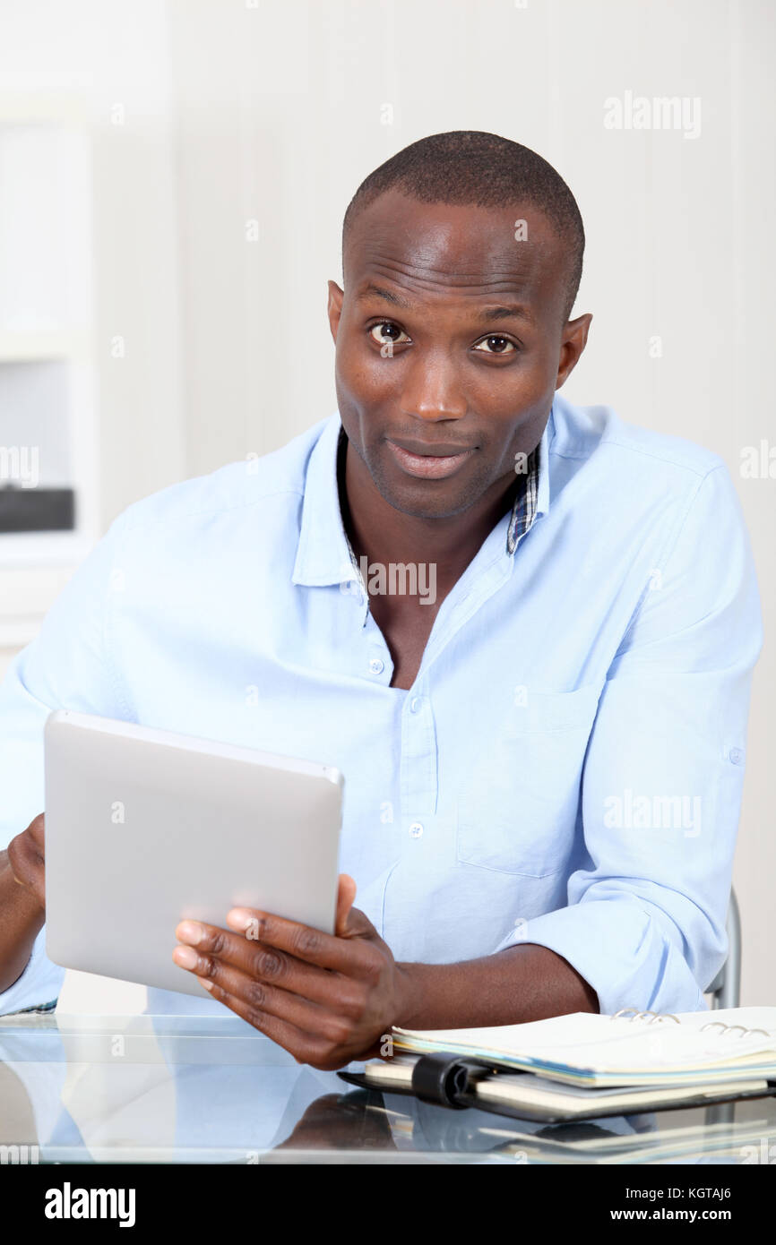 Office worker using electronic tablet at work Stock Photo - Alamy