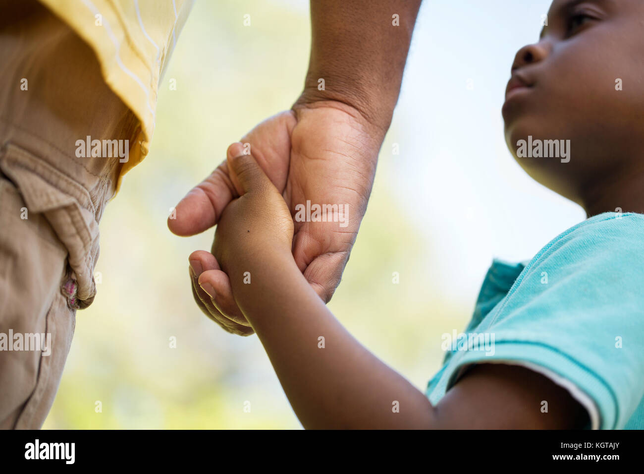 Two boys holding hands hi-res stock photography and images - Alamy
