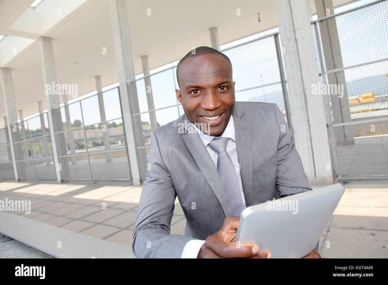 Salesman on business travel using electronic tablet Stock Photo - Alamy