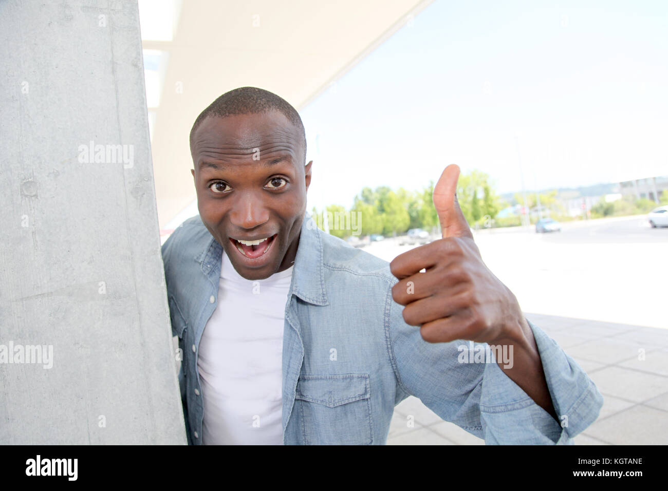 Portrait of smiling man showing thums up Stock Photo - Alamy