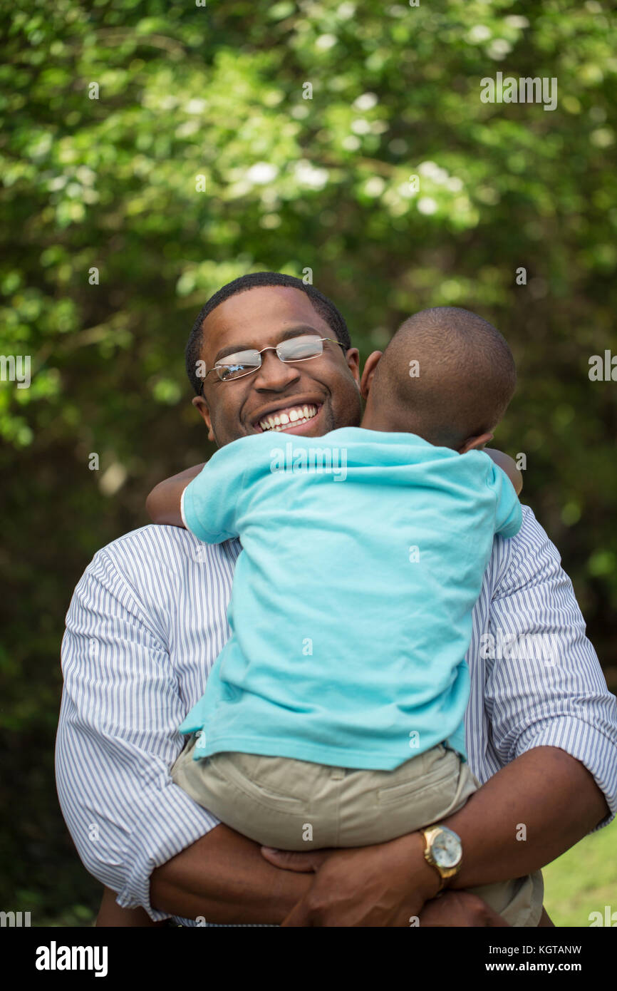 Father hugging his his son Stock Photo - Alamy