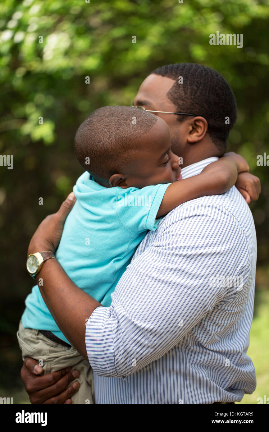 Father hugging his his son Stock Photo - Alamy