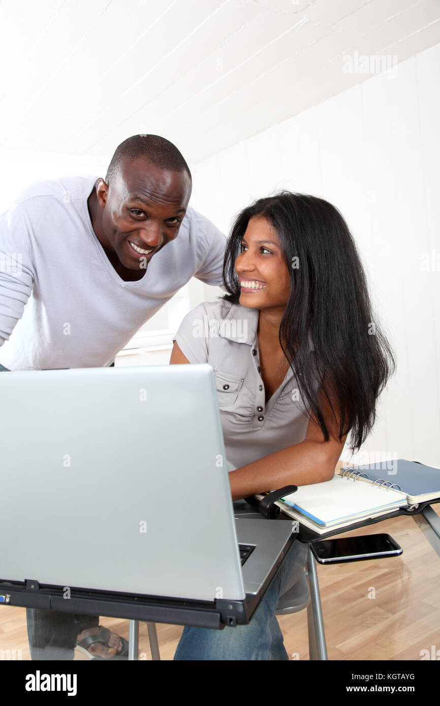 Workmates in office with laptop computer Stock Photo - Alamy