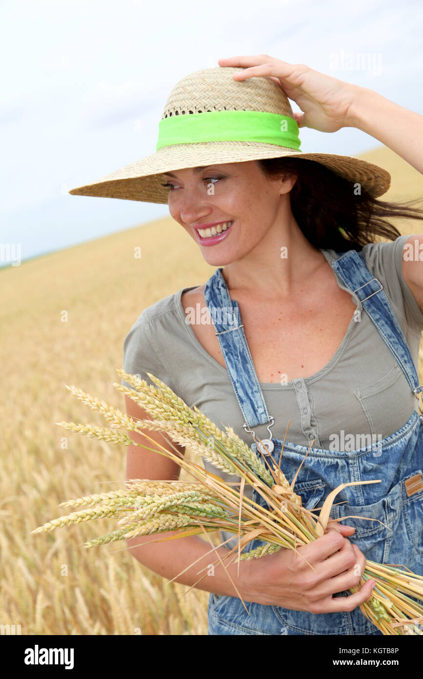 Woman in straw hat overalls hi-res stock photography and images - Alamy