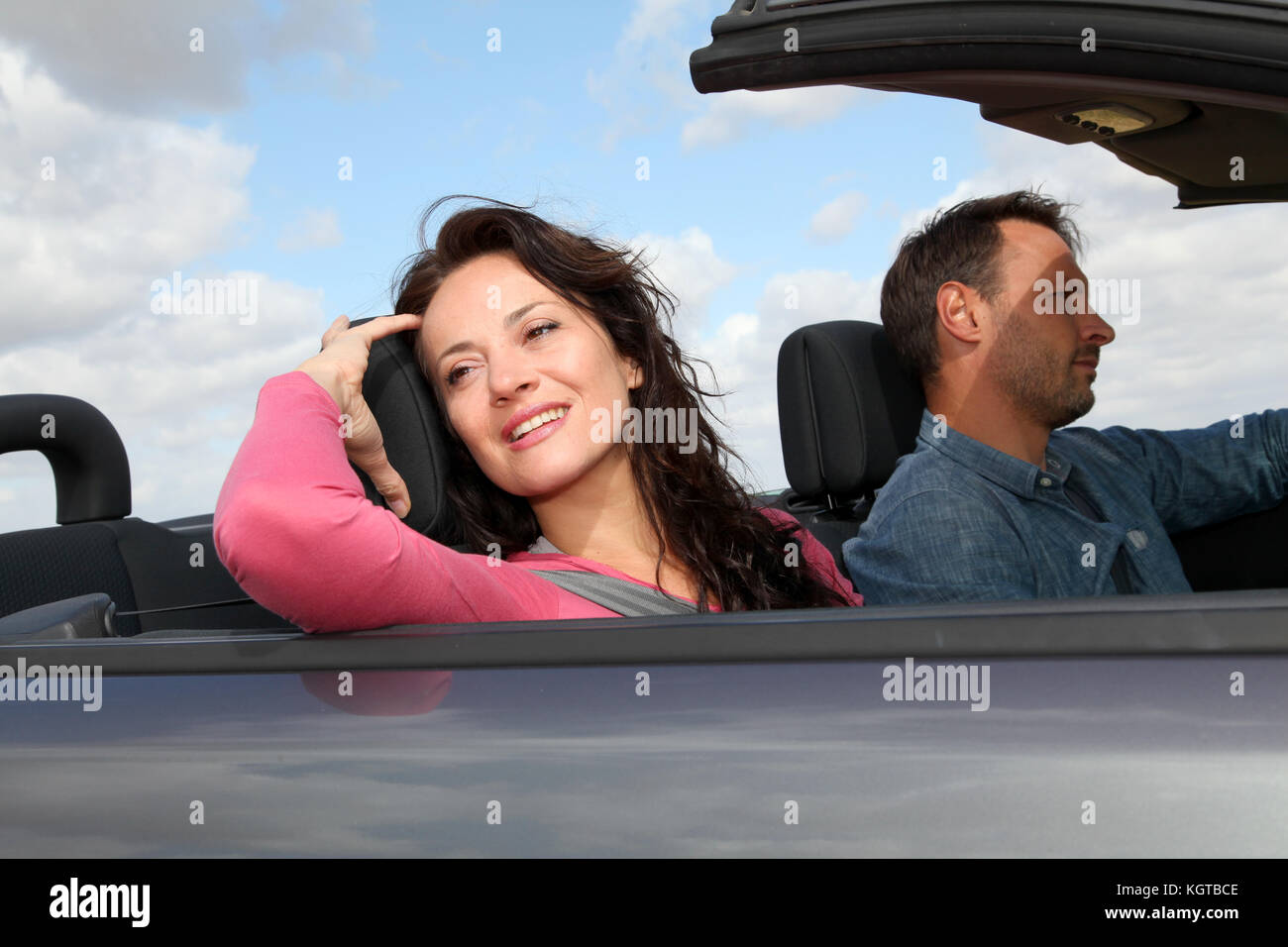 Couple riding convertible car Stock Photo - Alamy