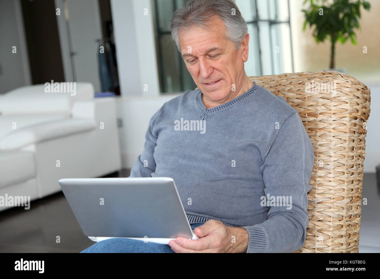 Senior man surfing on internet at home Stock Photo - Alamy