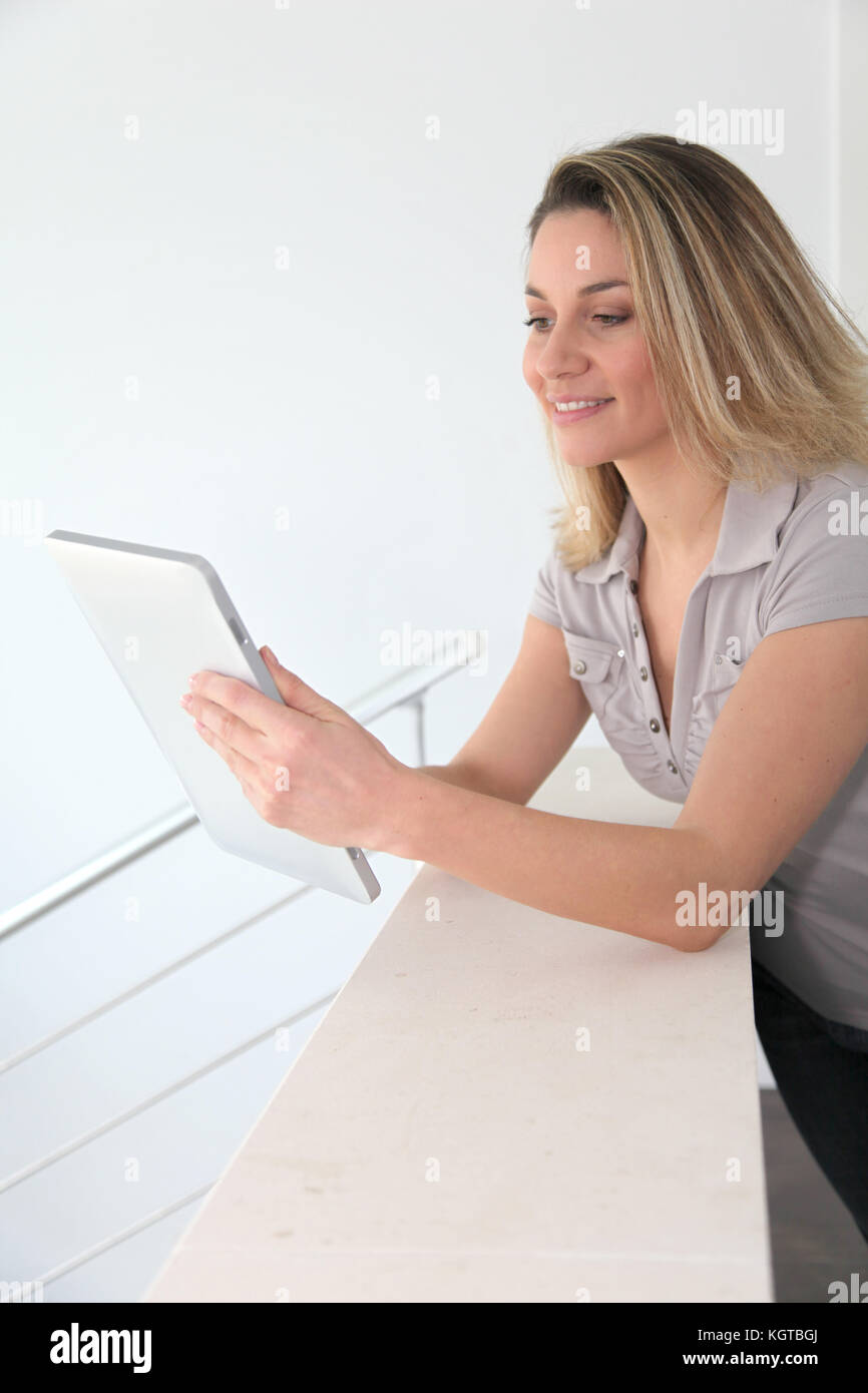 Woman using electronic tablet at home Stock Photo - Alamy