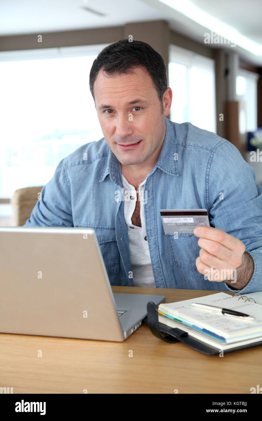 Man in front of computer doing online payment Stock Photo - Alamy