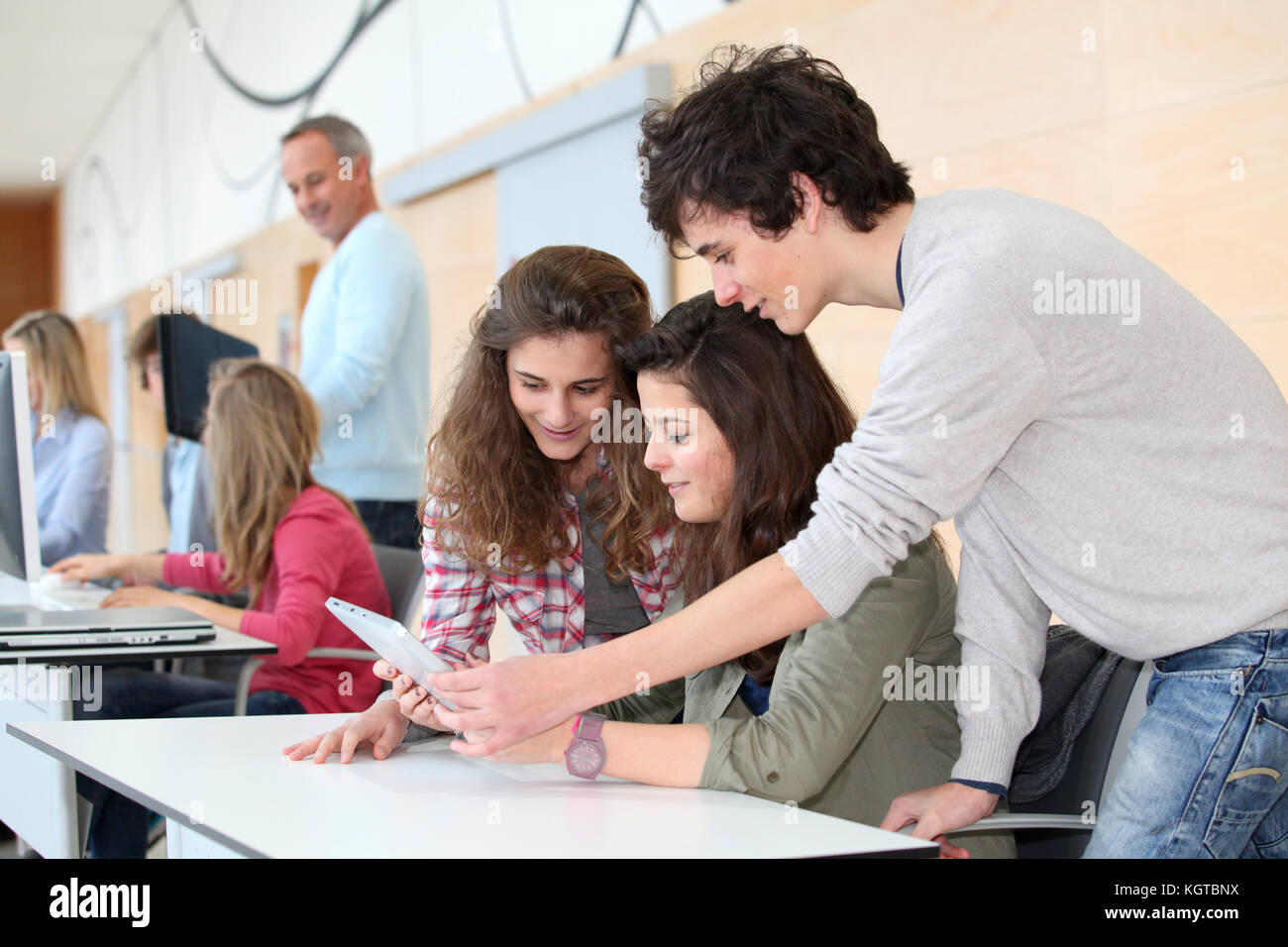 Group of teenagers in classroom with electronic tablet Stock Photo - Alamy