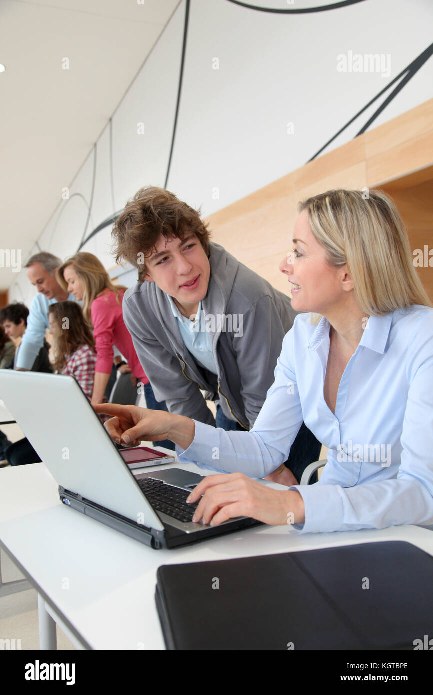 Teacher and student in training course at school Stock Photo - Alamy