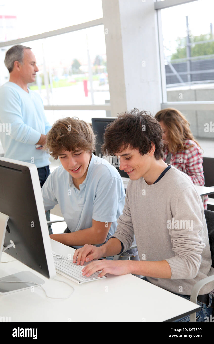 Teacher and students in classroom Stock Photo - Alamy