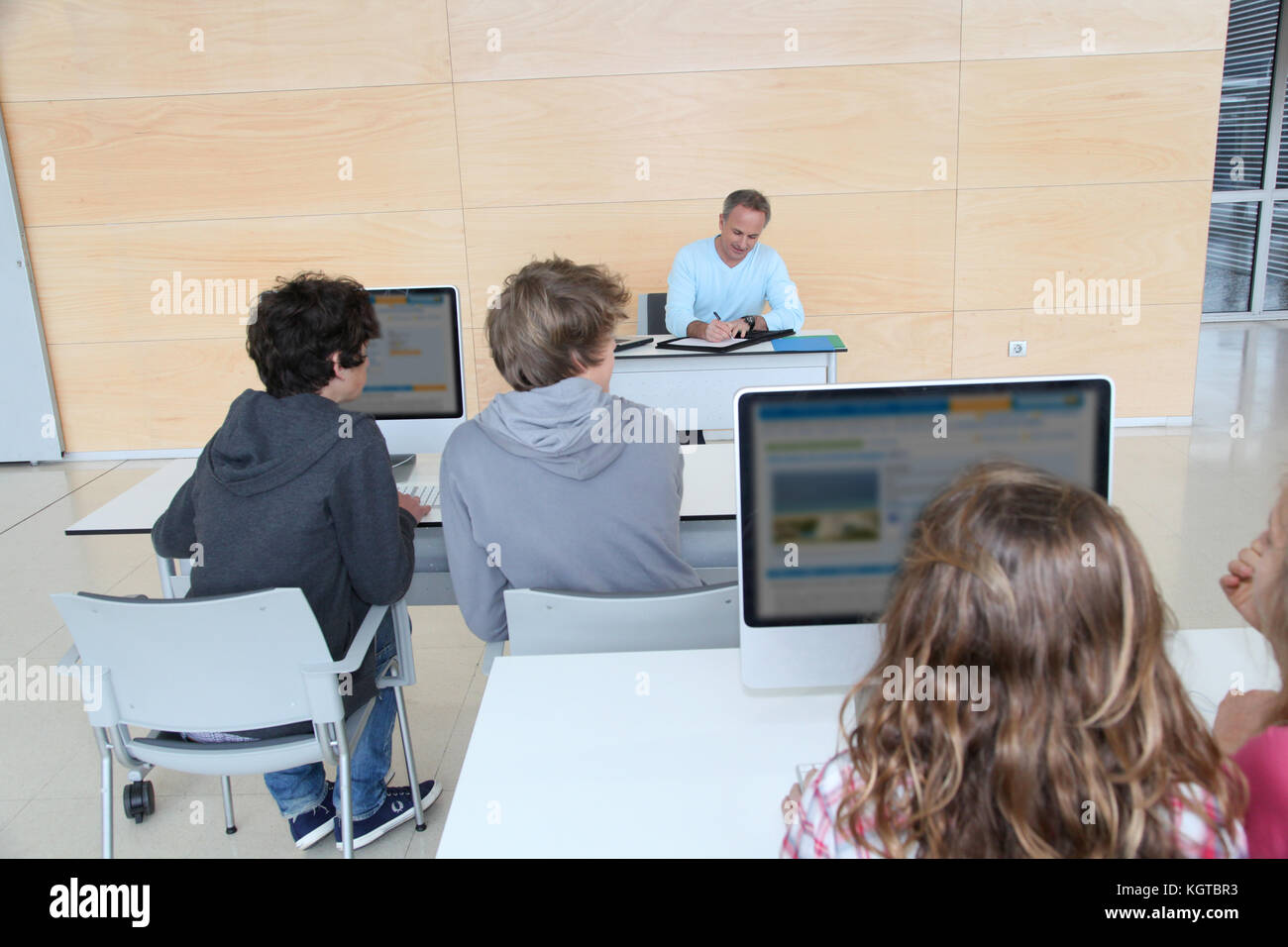 Teacher and students in classroom Stock Photo - Alamy