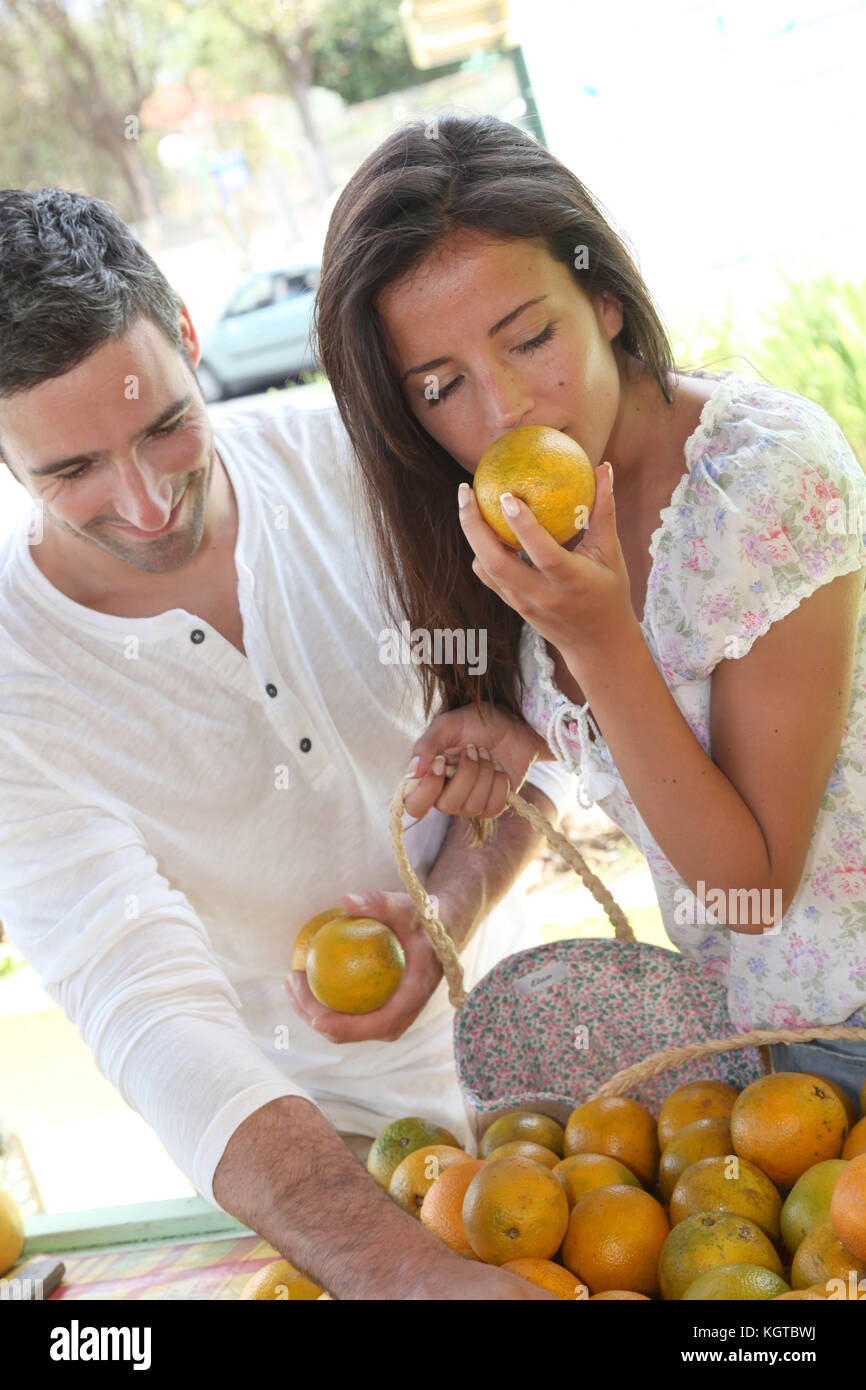 Cheerful couple choosing fruits in outdoor market Stock Photo - Alamy
