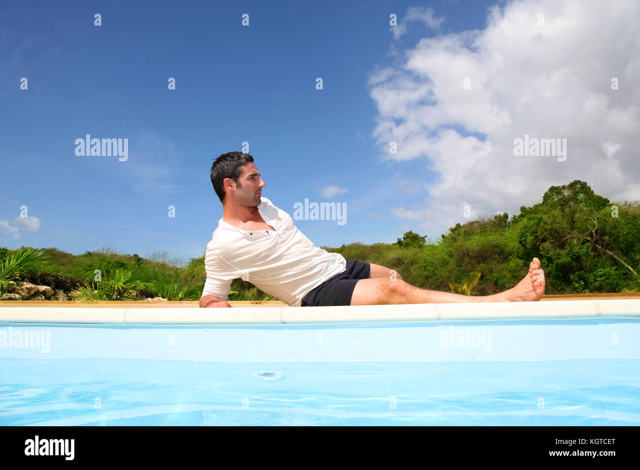 Man doing exercises by the pool Stock Photo - Alamy
