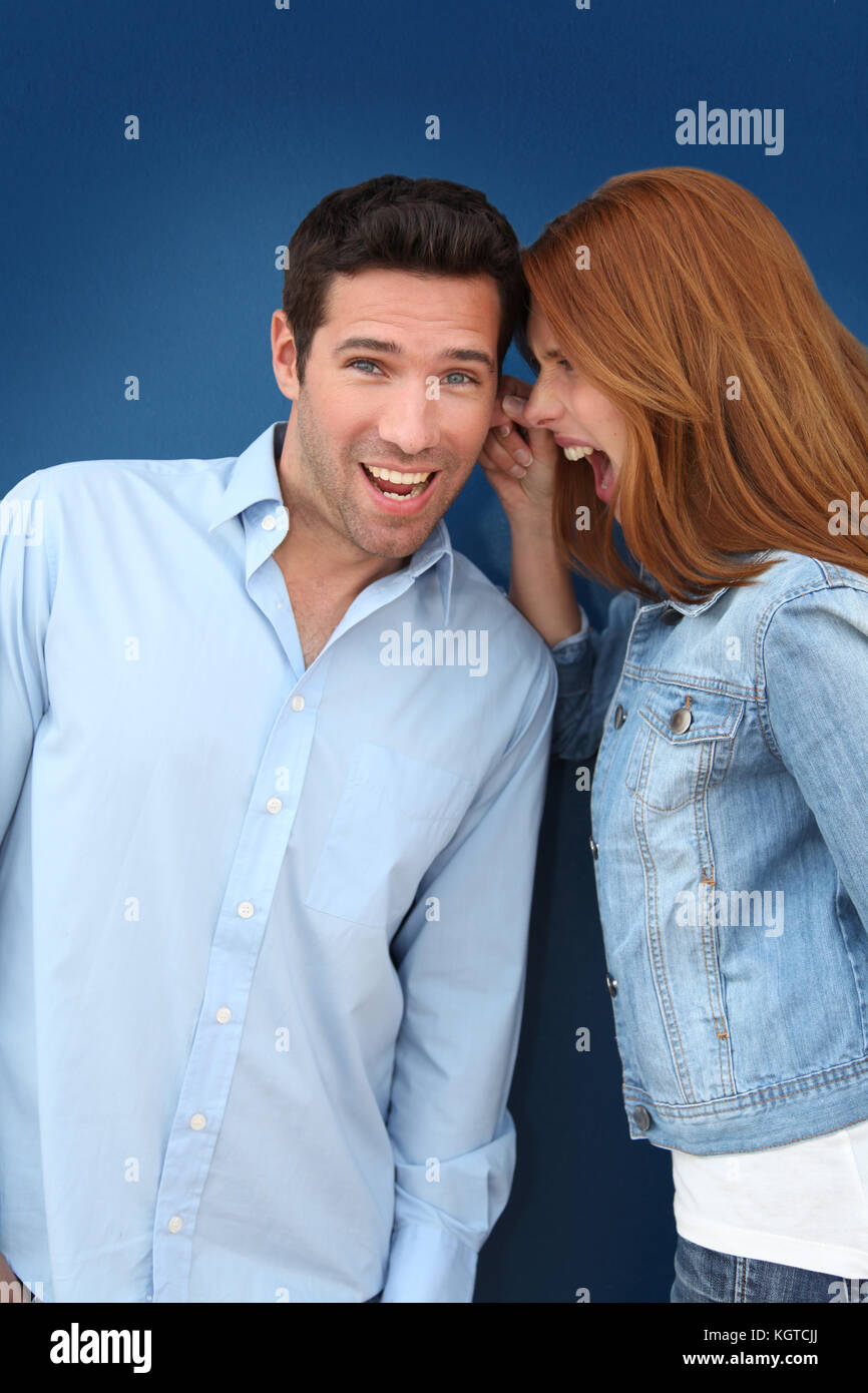 Woman pulling on her boyfriend's ears Stock Photo - Alamy