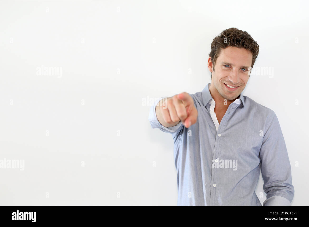 Adult man pointing at camera on white background Stock Photo - Alamy