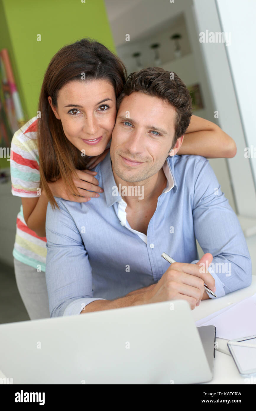 Couple at home sitting in front of laptop Stock Photo - Alamy