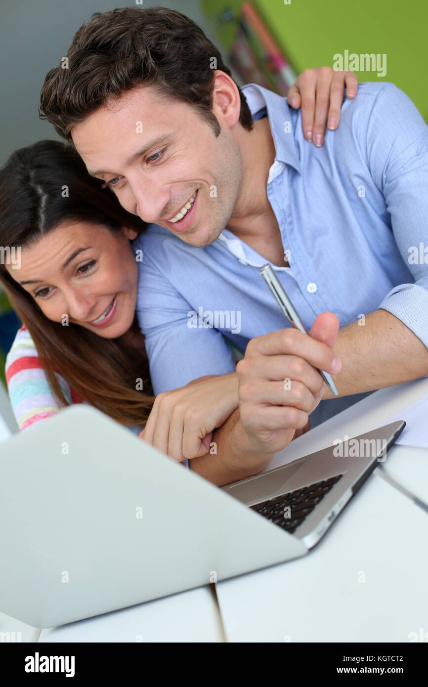 Couple at home sitting in front of laptop Stock Photo - Alamy
