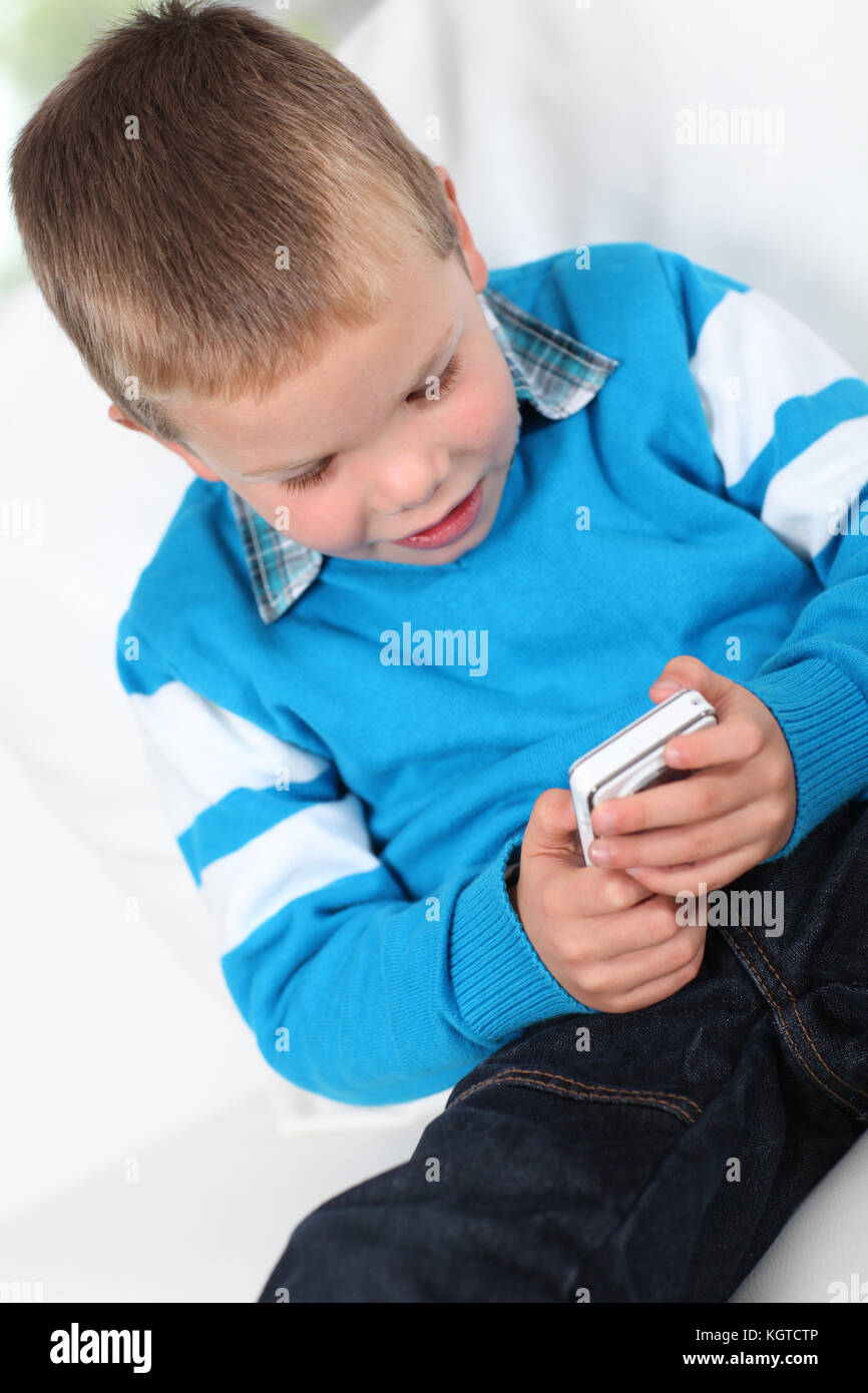 Little boy playing with smartphone Stock Photo - Alamy