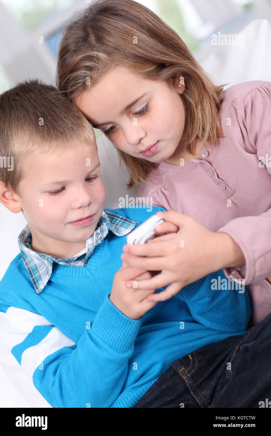 Children playing with smartphone Stock Photo - Alamy