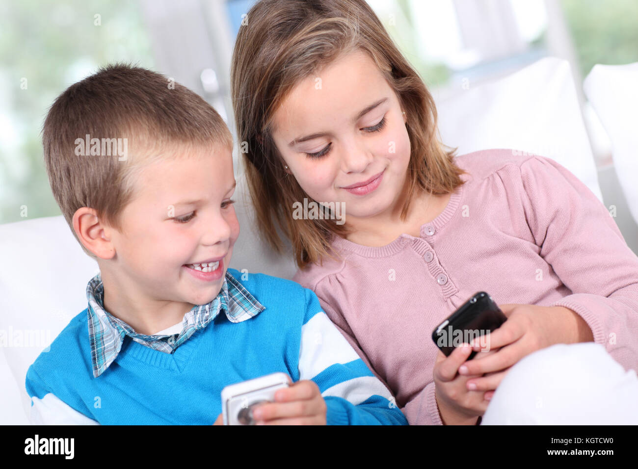 Children playing with smartphone Stock Photo - Alamy