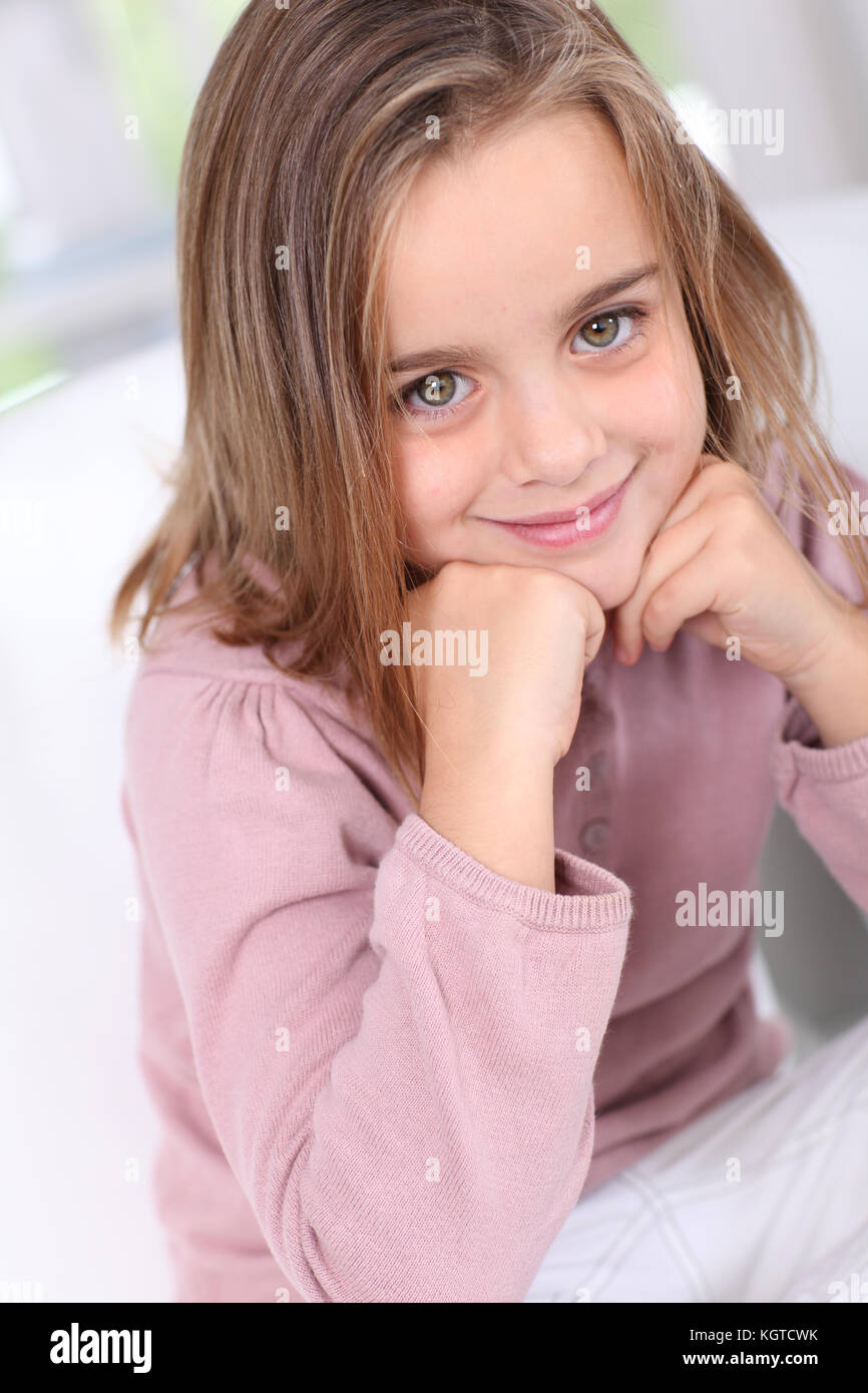 Portrait of cute little girl with hands on chin Stock Photo - Alamy