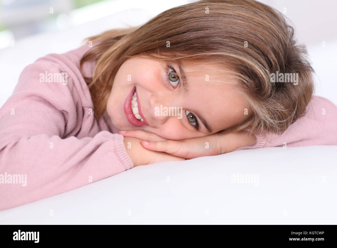 Portrait of cute little girl with hands on chin Stock Photo - Alamy