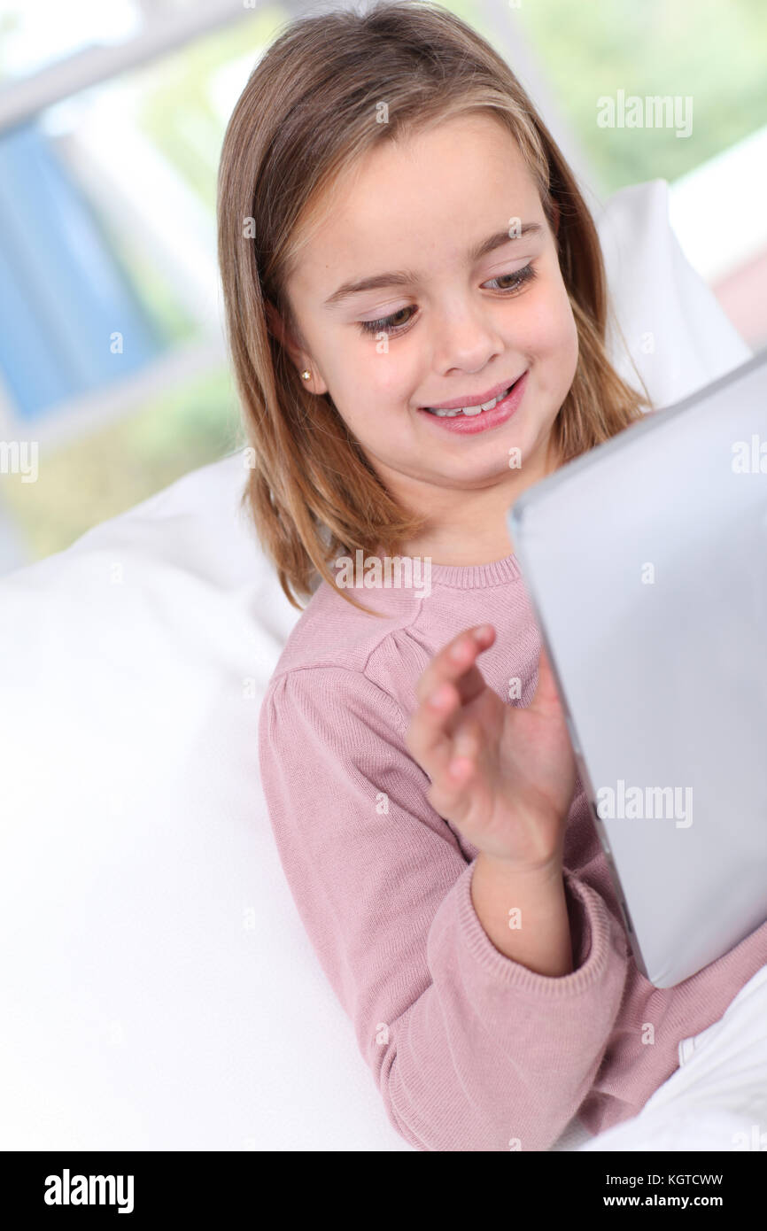 Portrait of little girl using electronic tablet Stock Photo - Alamy