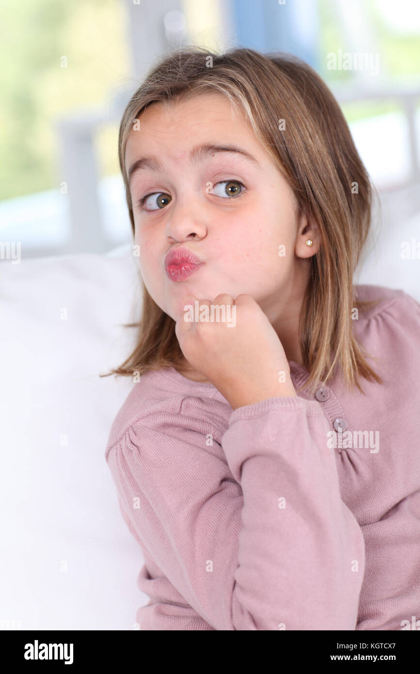Portrait of little girl with doubtful look Stock Photo - Alamy