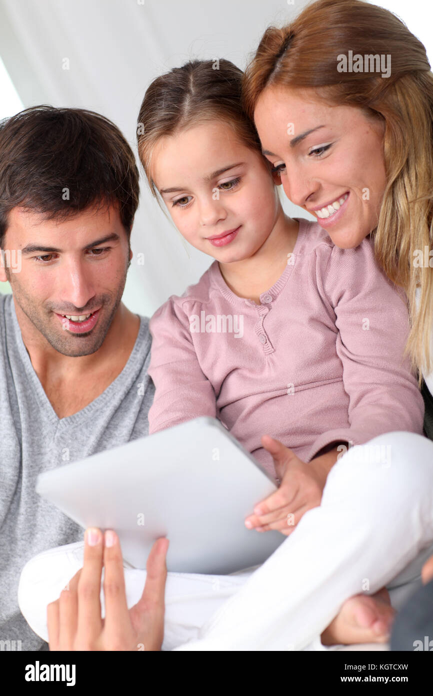 Family using electronic tablet at home Stock Photo - Alamy