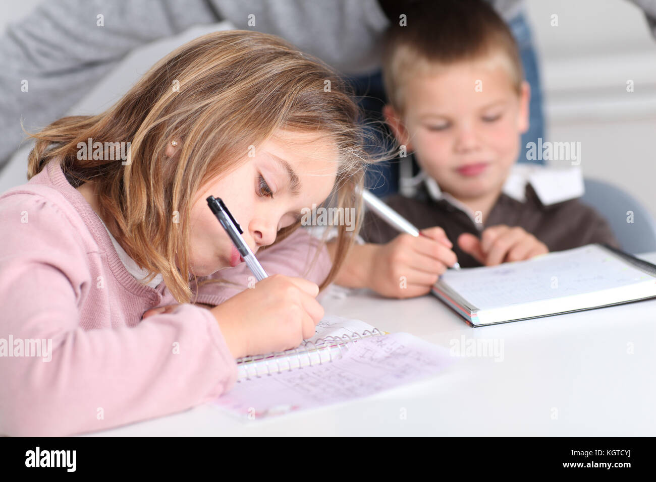 Kids at school doing their homework Stock Photo - Alamy