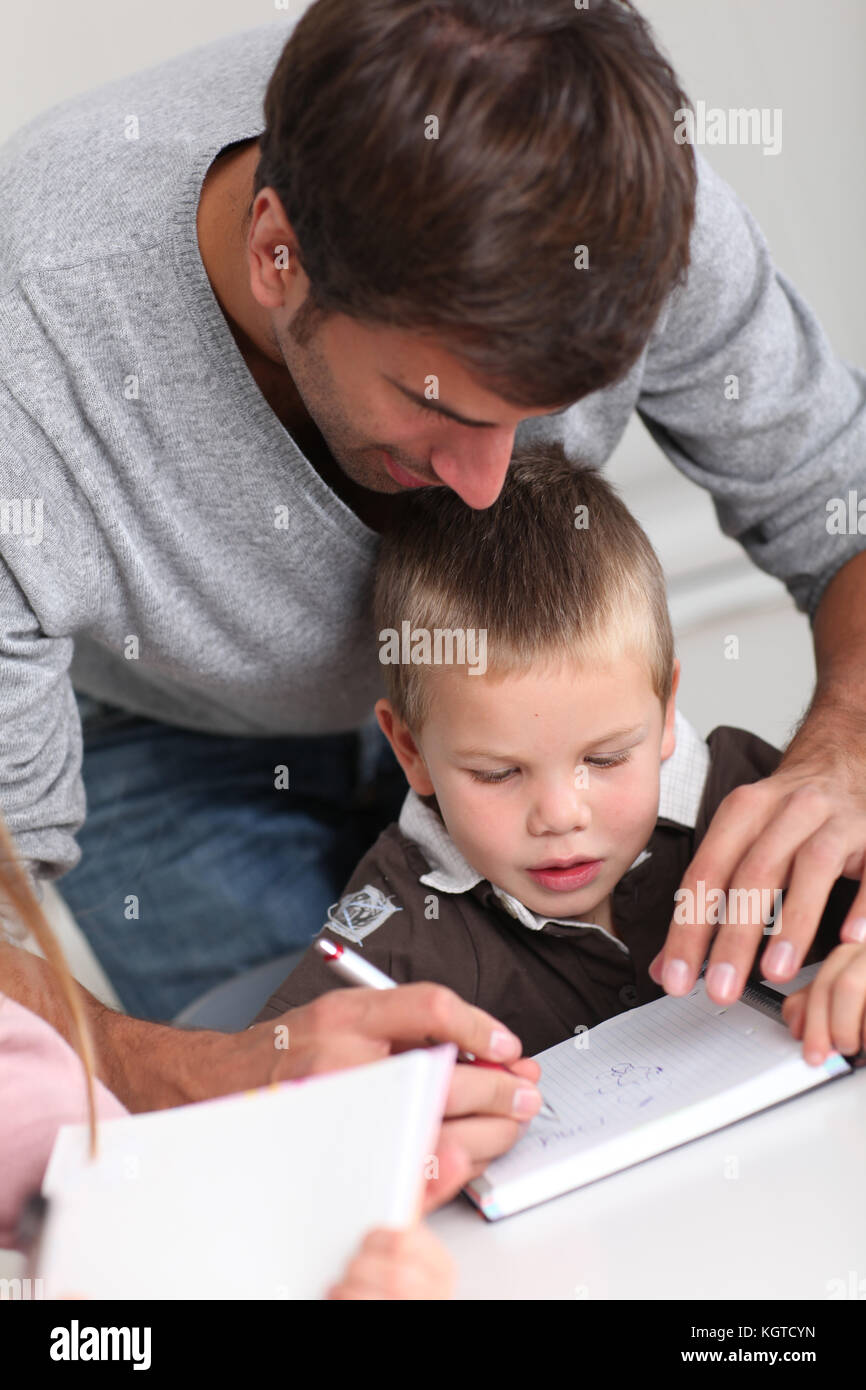 Man helping kids with homework Stock Photo - Alamy