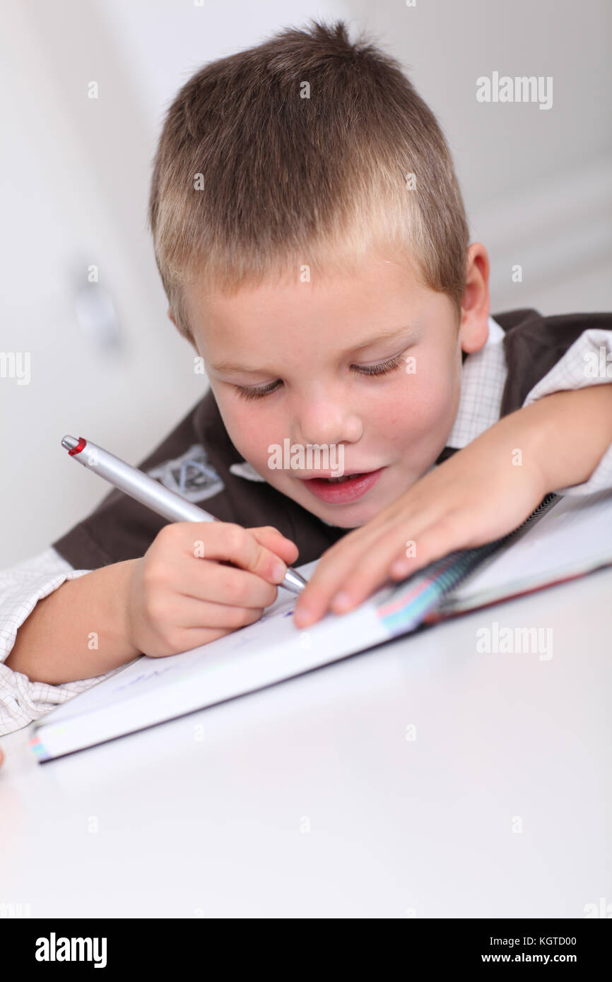 Portrait of little boy doing homework Stock Photo - Alamy
