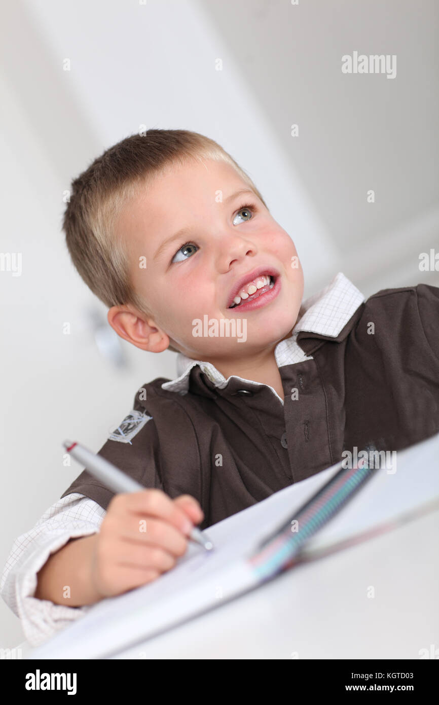 Portrait of little boy doing homework Stock Photo - Alamy