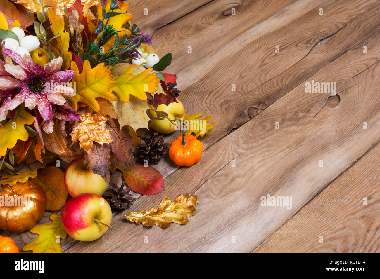 Rustic fall background with silk flowers, apples, golden pumpkin and ...