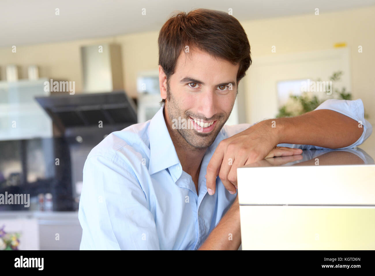 Smiling man standing in domestic kitchen Stock Photo - Alamy