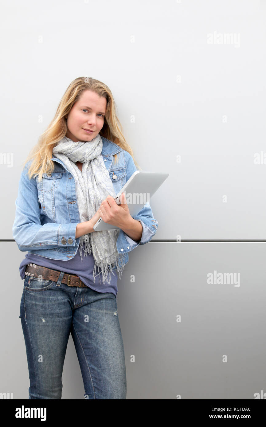 Blond woman using electronic tablet Stock Photo - Alamy