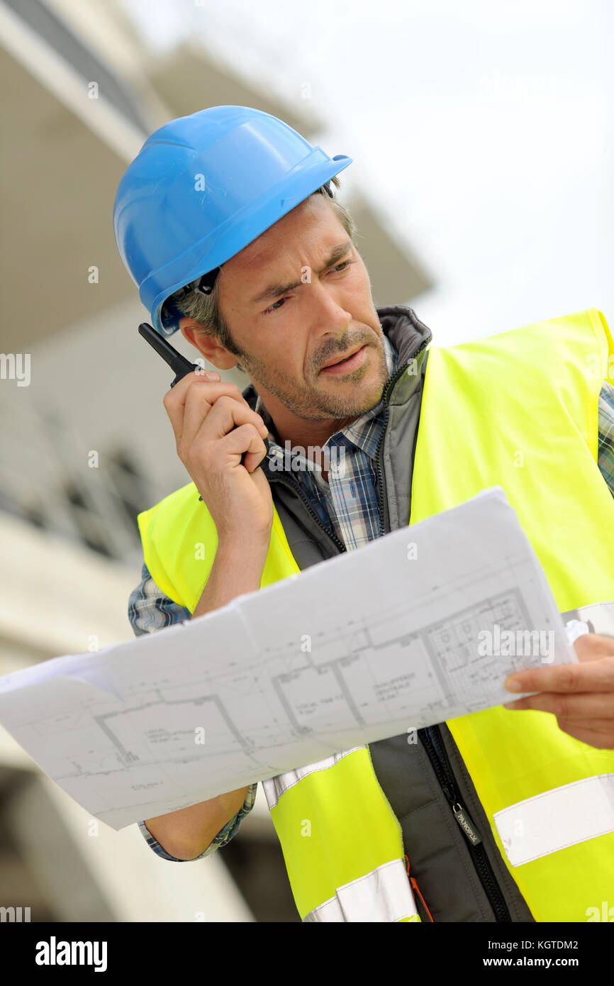 Portrait of construction manager using walkie-talkie Stock Photo - Alamy