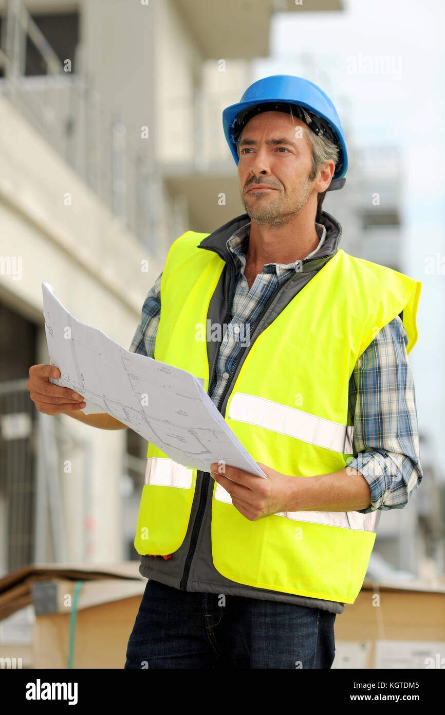Construction manager checking building site Stock Photo - Alamy