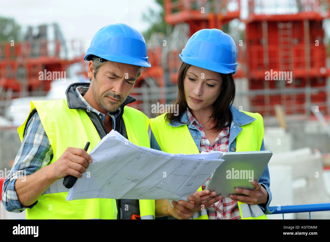 Engineers on building site controlling project Stock Photo - Alamy