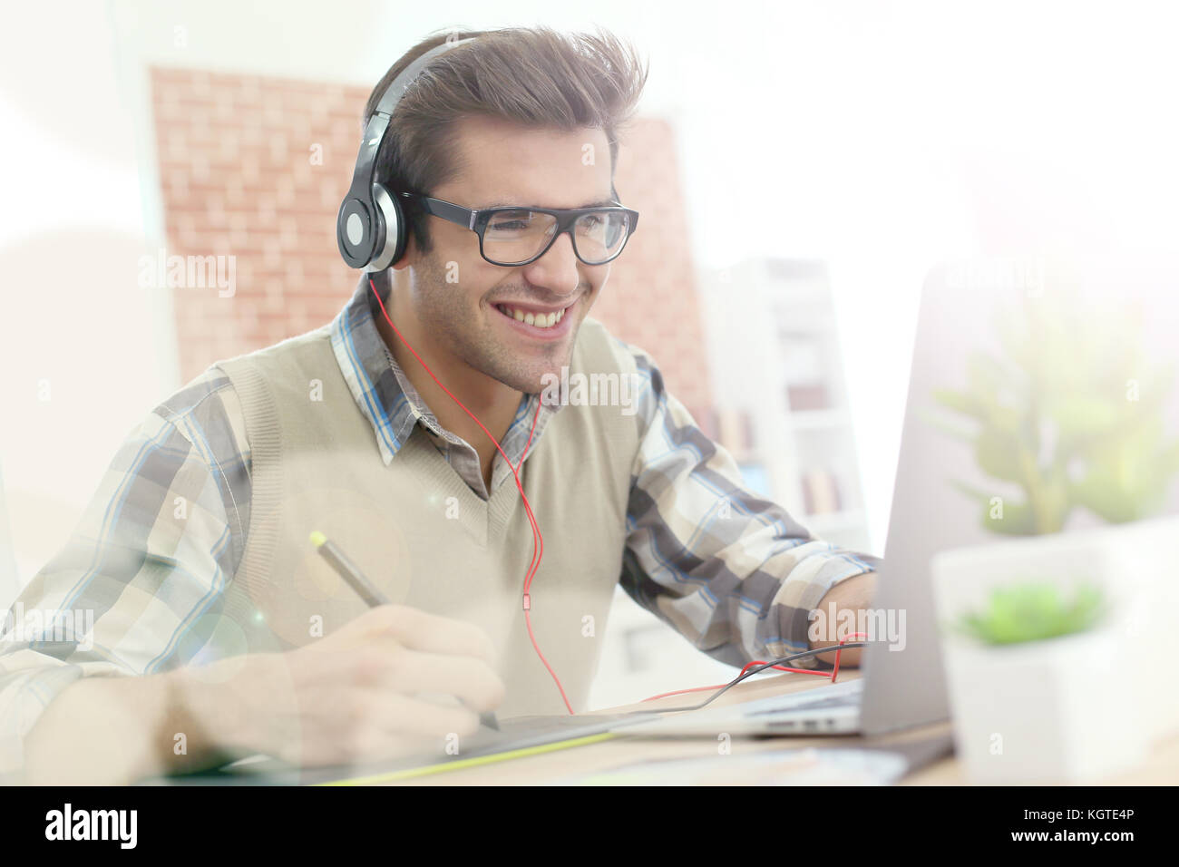 Young man in office using graphic tablet Stock Photo - Alamy