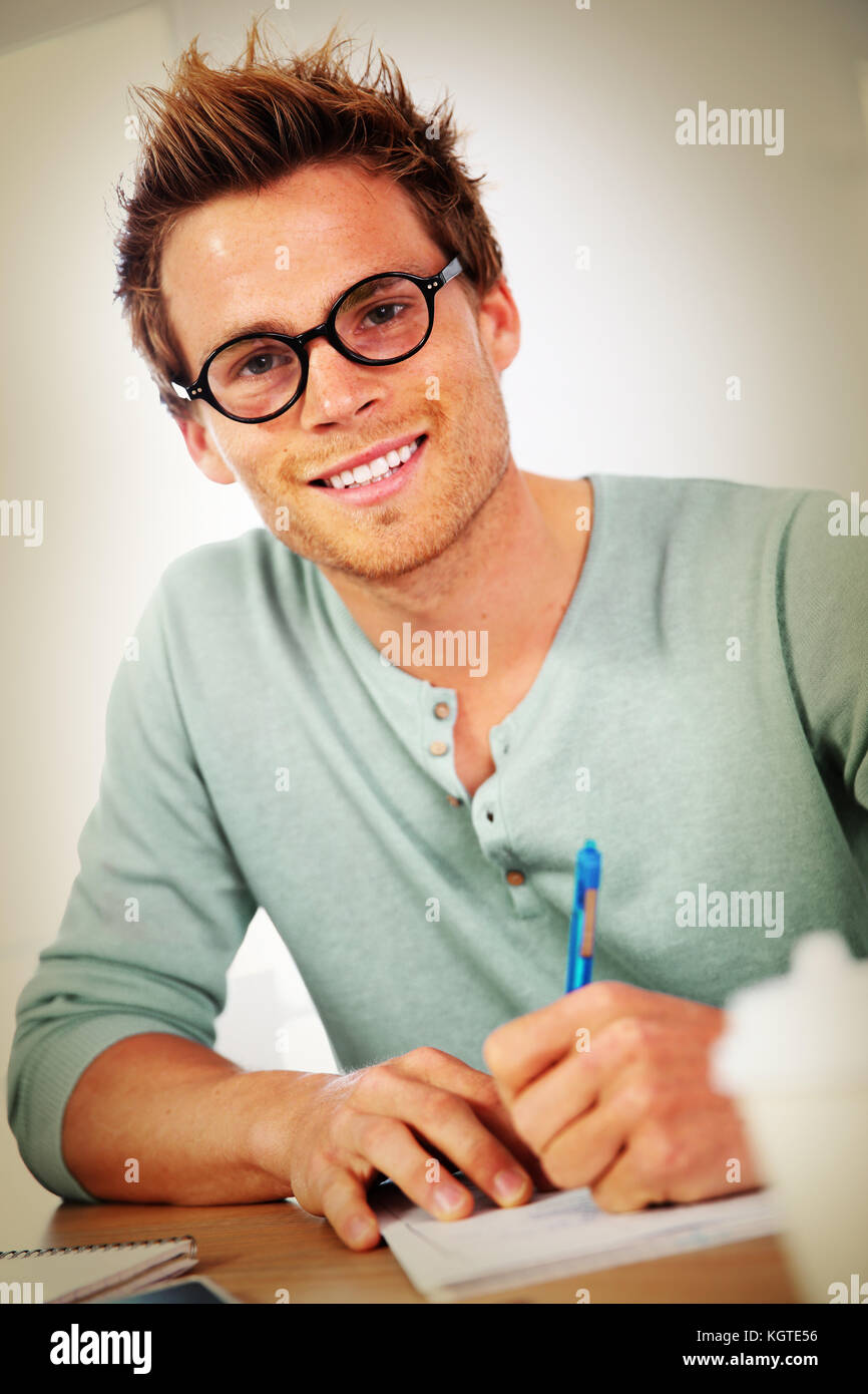 Portrait of young man filling in application form Stock Photo - Alamy