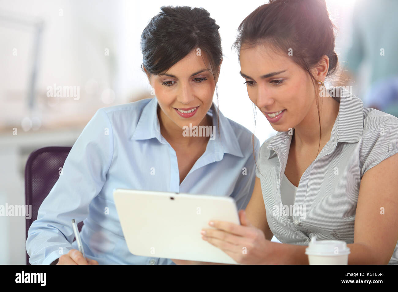 Young business girls working together on project Stock Photo - Alamy
